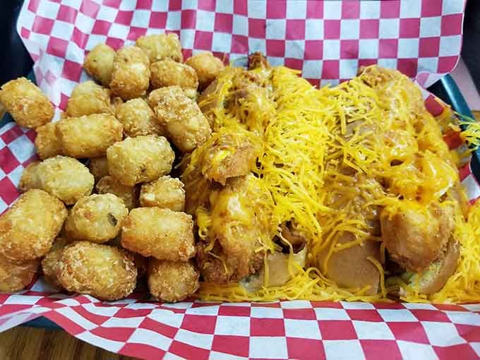 Crispy tater tots piled high next to chili cheese fries, because sometimes more really is more.