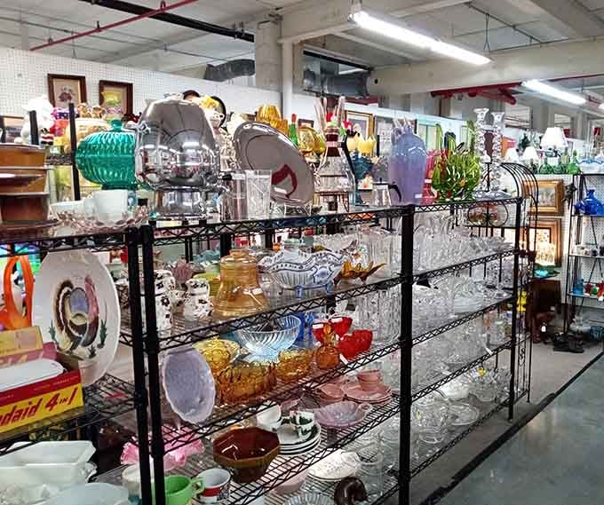 Glassware in every hue sparkles under the lights, turning ordinary shelving into a rainbow of vintage perfection.