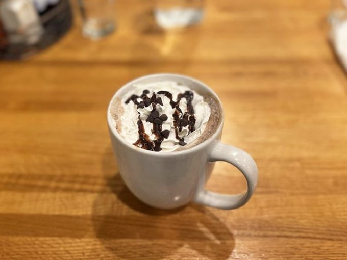 Hot chocolate topped with whipped cream and chocolate drizzle. Sometimes simple pleasures are the best ones.