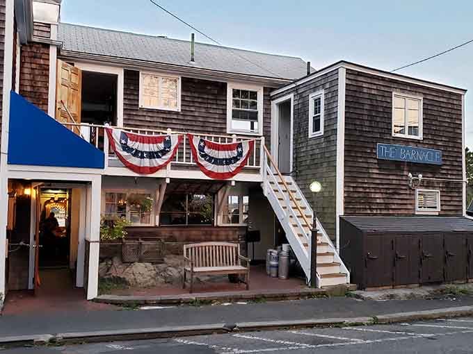 The Barnacle wears its patriotic bunting proudly, shingled and charming like a postcard from maritime America.
