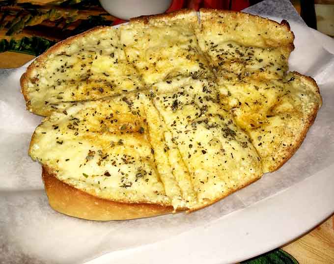 Garlic bread so buttery and herb-kissed, it could be a meal all by itself, honestly.