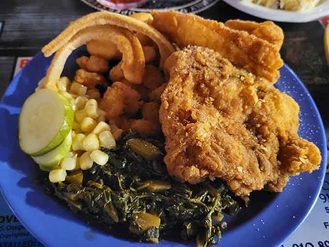 Golden fried chicken, collard greens, and all the Southern sides your heart desires on one glorious plate.