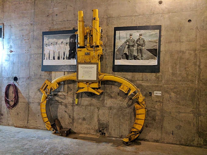 Yellow industrial equipment stands as a monument to the engineering required to house weapons of mass destruction.
