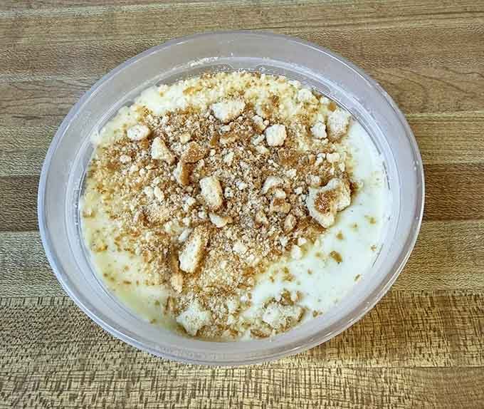 Banana pudding topped with vanilla wafers and crumbles, the kind of dessert that erases bad days.