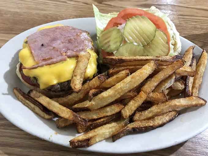 A burger this loaded with ham and cheese requires serious architectural skills and an empty stomach to conquer.