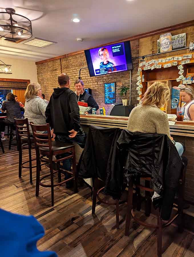 Exposed brick and warm lighting create the kind of atmosphere where strangers become friends over cold beverages.