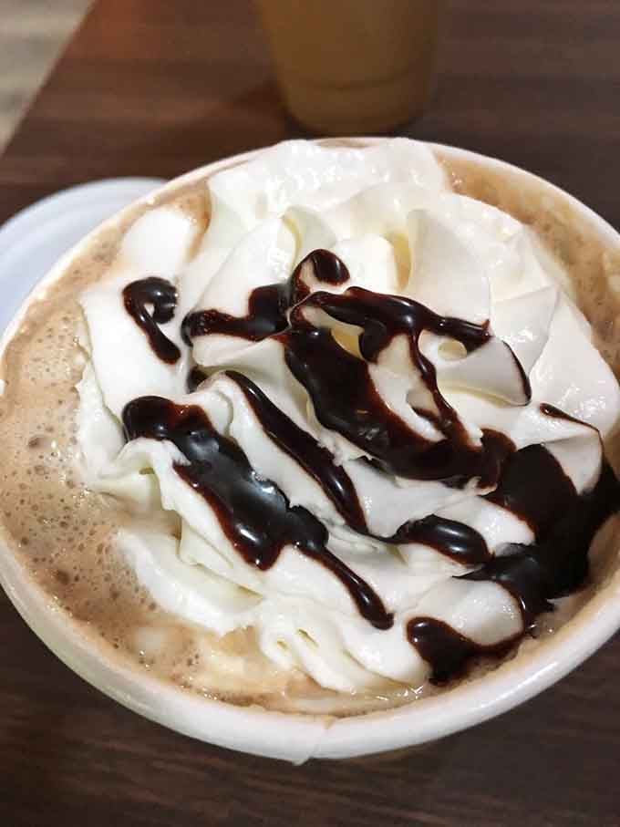 Hot drinks topped with whipped cream and drizzle, paired with quiche that makes breakfast feel downright magical.