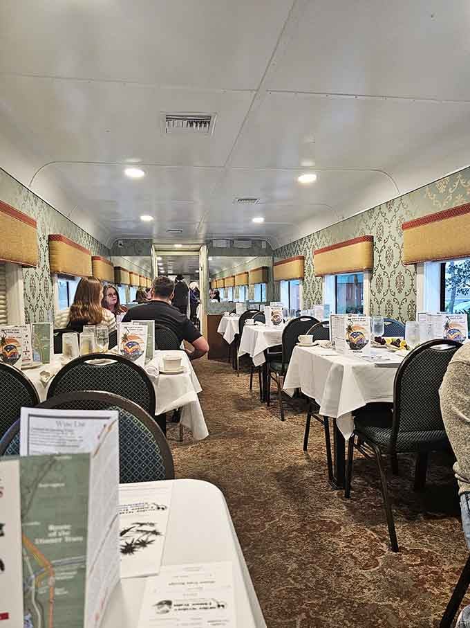 White tablecloths and proper place settings transform this vintage train car into an elegant dining room that happens to be moving.