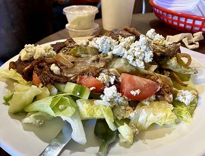 Blue cheese crumbles scattered across fresh greens remind you that even soda shops understand salad has its place.