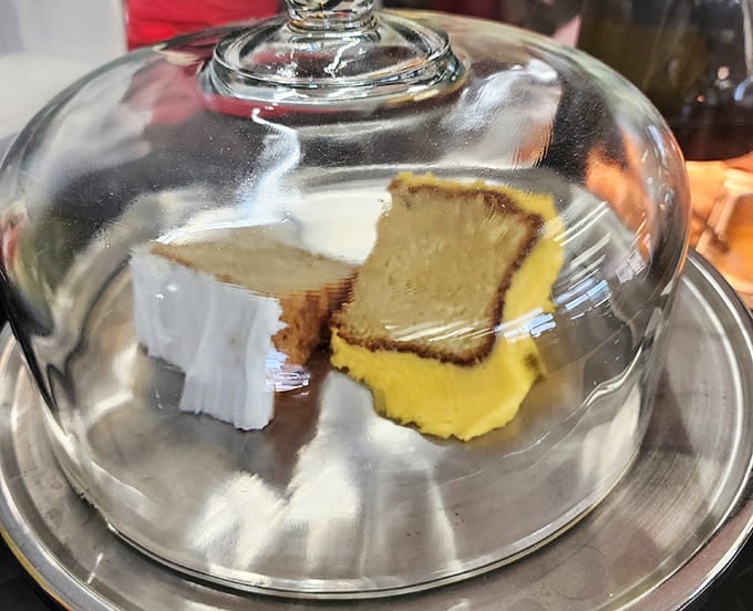 Cake under glass like a museum exhibit, except this art is meant to be devoured immediately.
