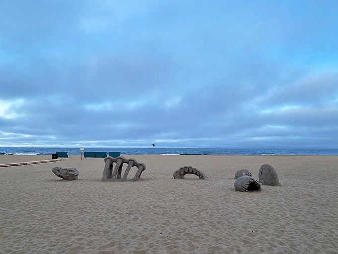 Someone built a sand creature that looks like it crawled from the depths to judge your vacation choices.