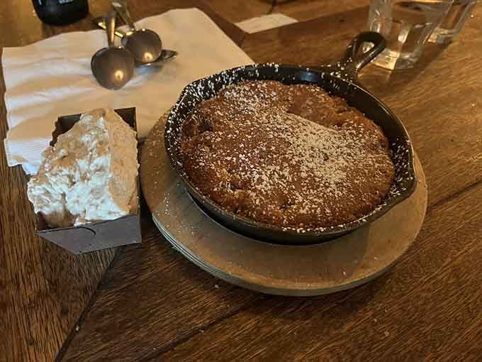 Cast iron chocolate chip cookie topped with house-made whipped cream: warm, gooey, absolutely irresistible perfection.