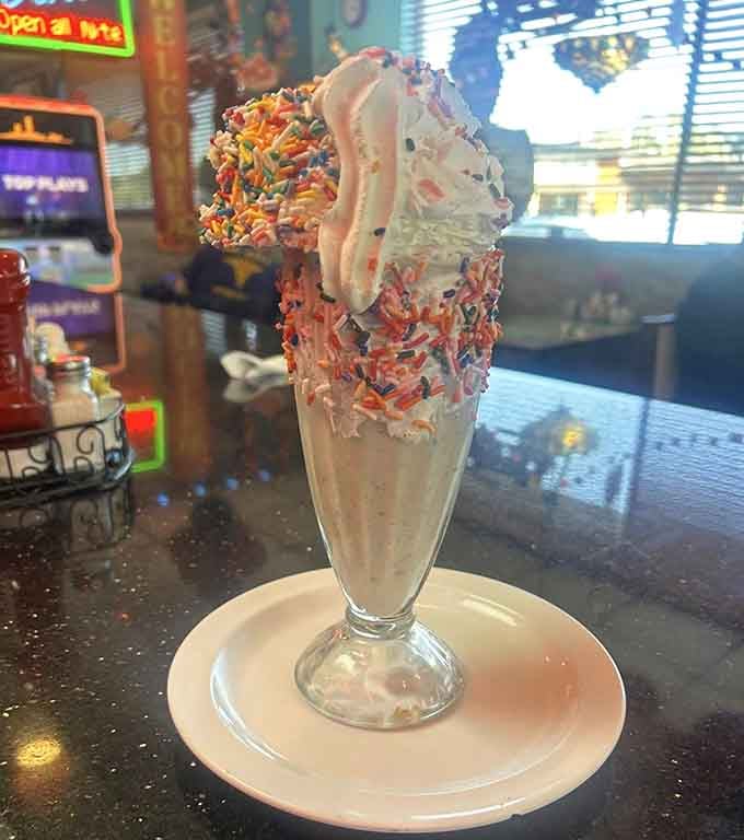 This towering milkshake topped with sprinkles and whipped cream is pure joy in a glass, no apologies needed.