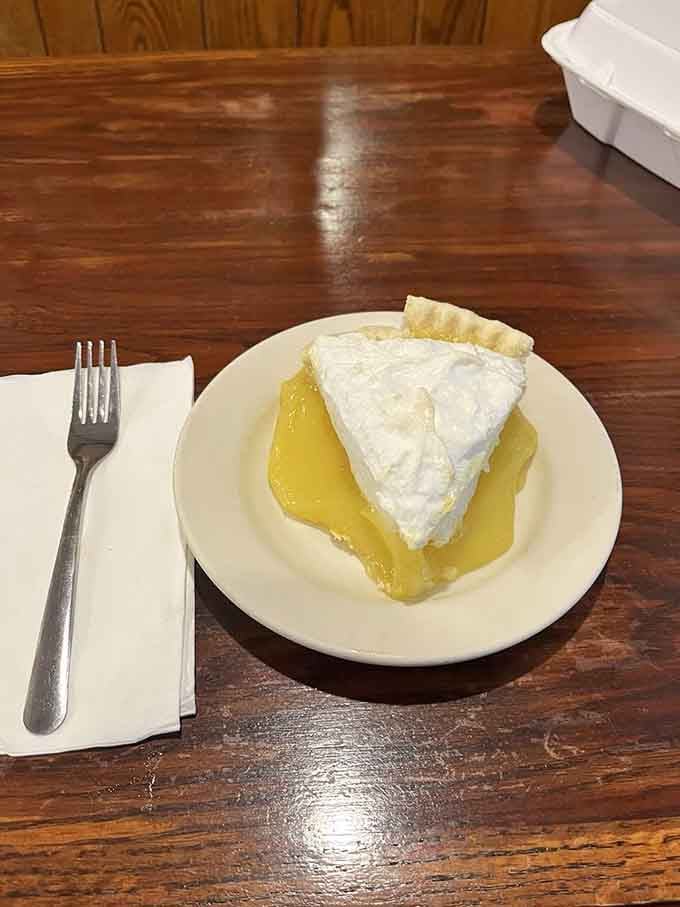 Lemon meringue pie with a cloud of topping that defies both gravity and your diet plans simultaneously.