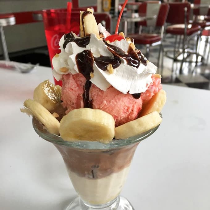 Three scoops of happiness crowned with whipped cream, chocolate sauce, and a cherry that earned its spot on top.