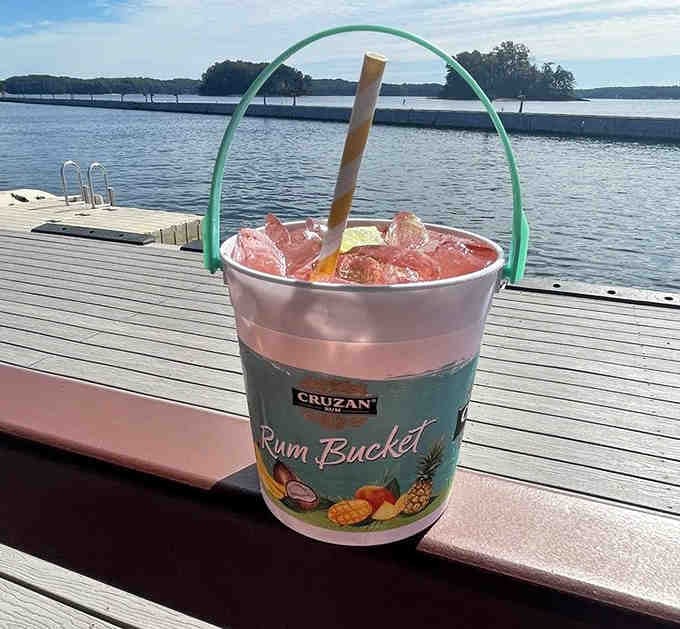 Rum bucket drinks served lakeside, because subtlety has no place at a proper tiki bar celebration.