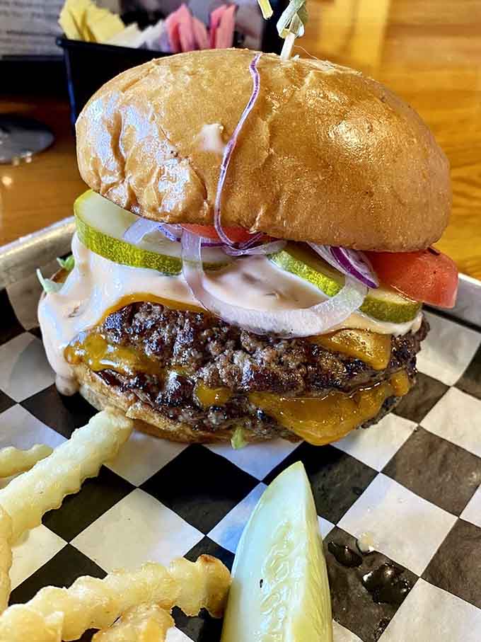 This burger means business with toppings piled so high it defies the laws of sandwich physics.