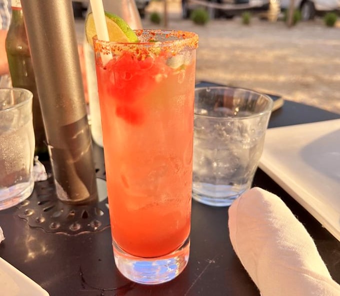 This coral-hued cocktail with its spicy rim practically glows in the late afternoon light by the water.