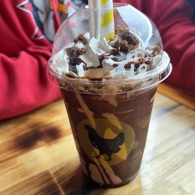 That chocolate shake topped with whipped cream and cookie crumbles is basically dessert wearing a beverage disguise.