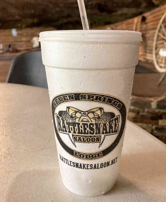 Even your beverage gets the Rattlesnake treatment, served in a foam cup bearing the saloon's signature fanged logo with pride.