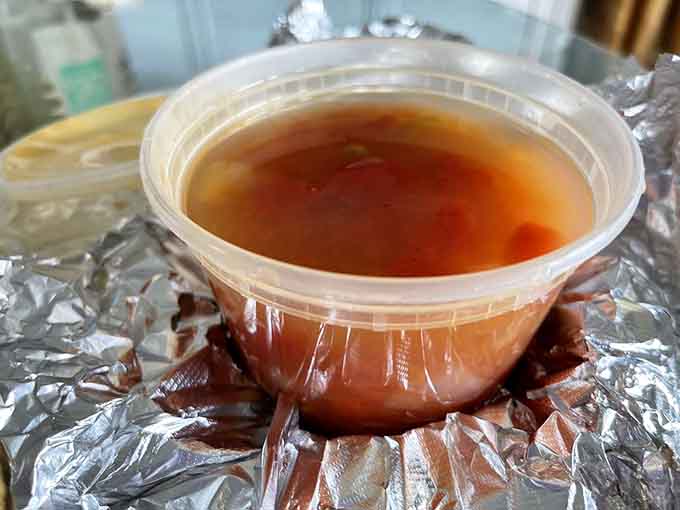 That rich amber broth holds secrets of the sea, warming you from the inside like a cozy sweater on a breezy boardwalk evening.