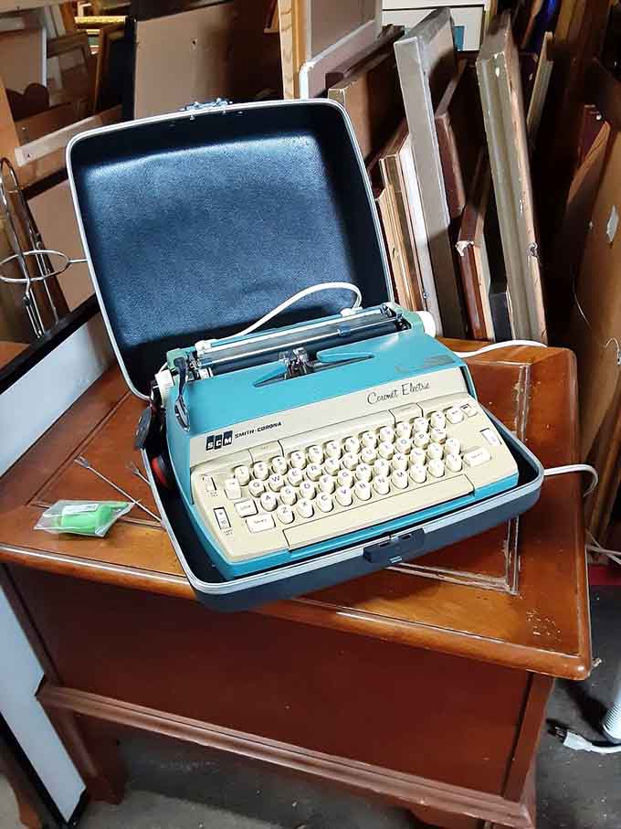 A turquoise typewriter in its original case, perfect for aspiring novelists or anyone missing that satisfying clack-clack sound.