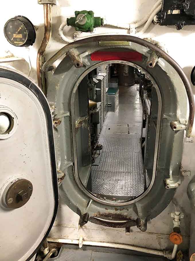 Step through this watertight bulkhead door and suddenly understand what "cramped quarters" really means for submarine crews.