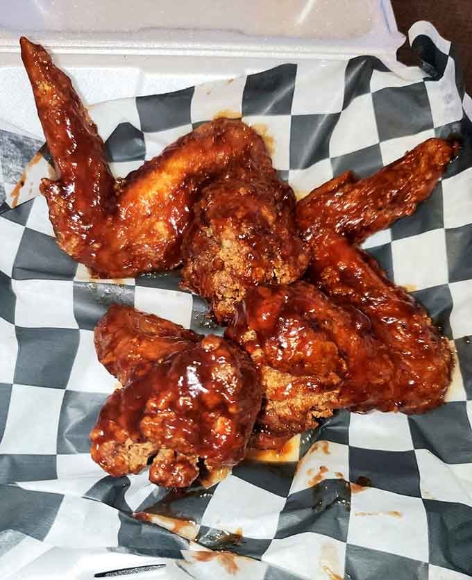 Wings glazed in sauce so shiny they could double as mirrors, if you weren't too busy devouring them immediately.