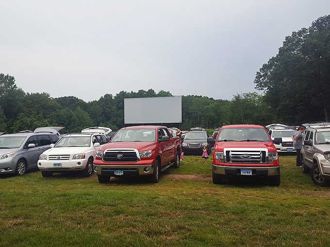 Trucks and SUVs gather on the grass, their occupants already staking claims for the best sightlines available.