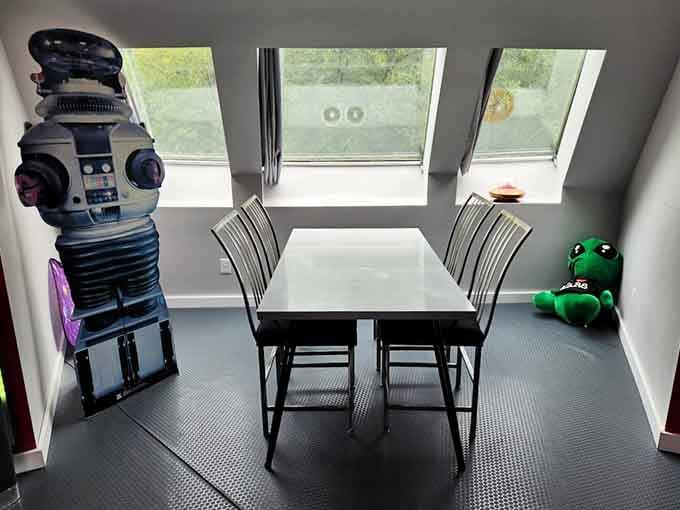 A dining area with skylight views and a life-size robot companion, because breakfast tastes better in outer space.