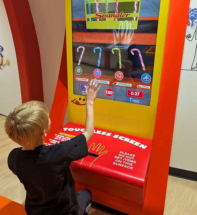 Kids discovering that touchscreens and candy make the perfect combination for modern museum entertainment and parental peace.