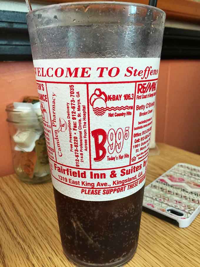 Sweet tea in a glass covered with local ads, multitasking like a true Southern beverage should.