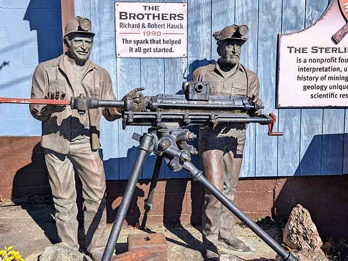 Life-sized miner statues stand ready with their drill, frozen in time like the world's most educational wax museum display.