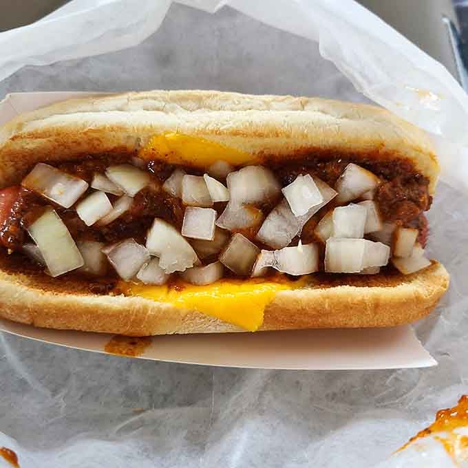 Chili cheese dogs piled high with toppings require extra napkins, zero apologies, and a healthy appetite for pure joy.