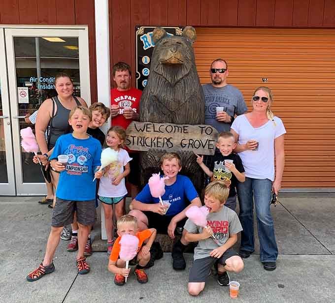 A carved wooden bear welcomes families to Stricker's Grove, the perfect photo op before the real adventures begin.