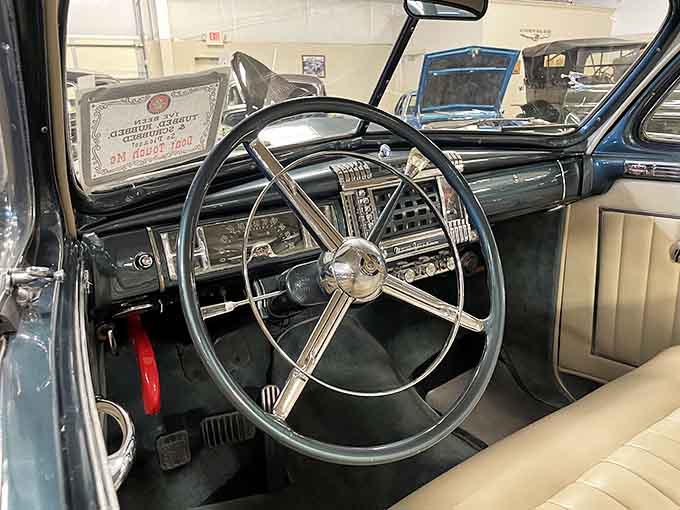 That chrome steering wheel and simple dashboard remind us when driving required actual skill, not just touchscreens.