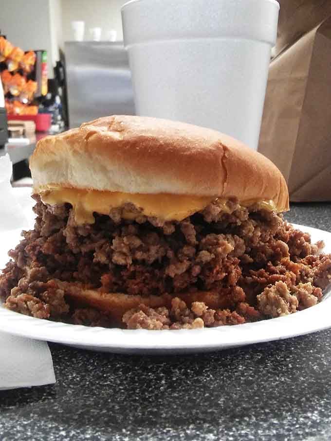 This burger sits atop a mountain of loose meat chili like a delicious edible throne of glory.
