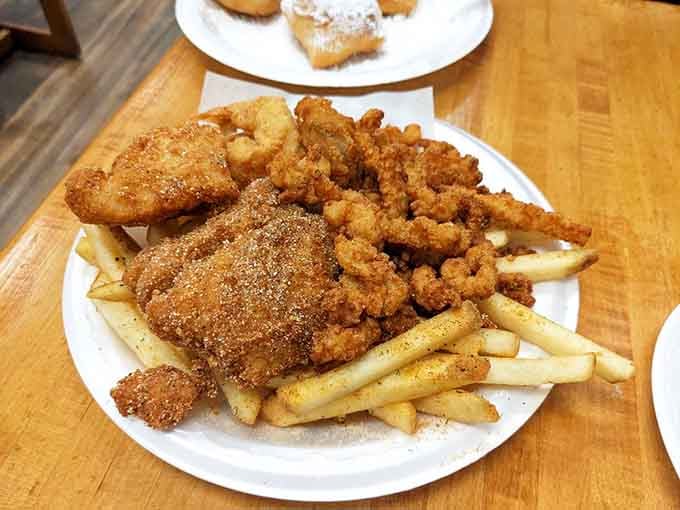 The seafood platter brings variety to your table&mdash;fried fish, shrimp, and fries creating a symphony of crunch and flavor.