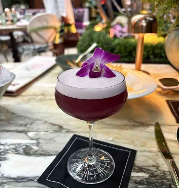 This cocktail topped with an orchid proves that drinks can be both beautiful and delicious, not just one.