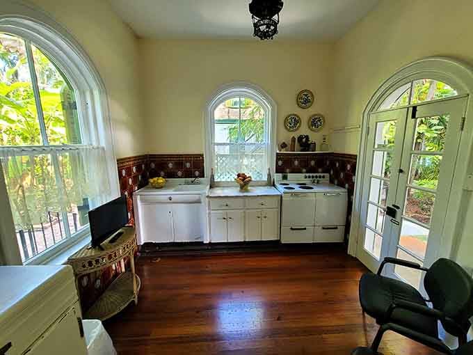 The vintage kitchen maintains its 1930s charm, right down to the arched windows and original cabinetry.