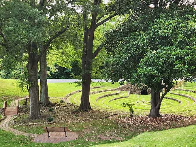 Mature trees create a natural cathedral around the labyrinth, offering shade and that peaceful rustling soundtrack nature provides.
