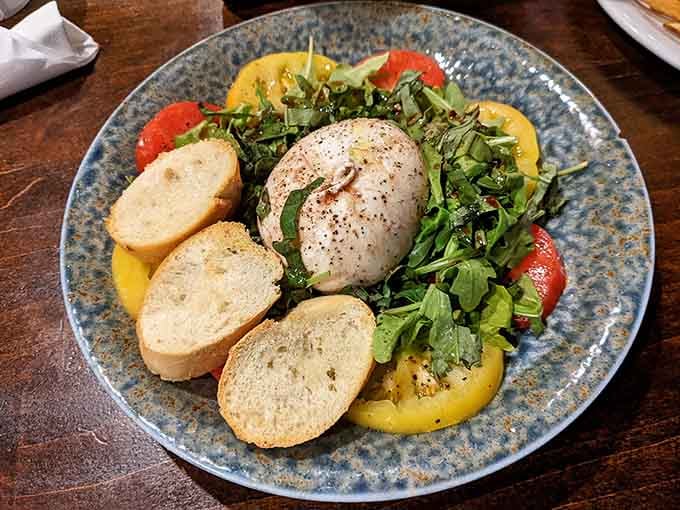 Fresh burrata nestled on heirloom tomatoes like edible art you actually want to destroy immediately.