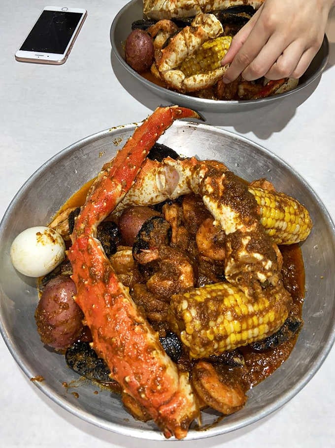 King crab legs towering over corn and potatoes like a delicious Jenga tower you're absolutely encouraged to demolish.