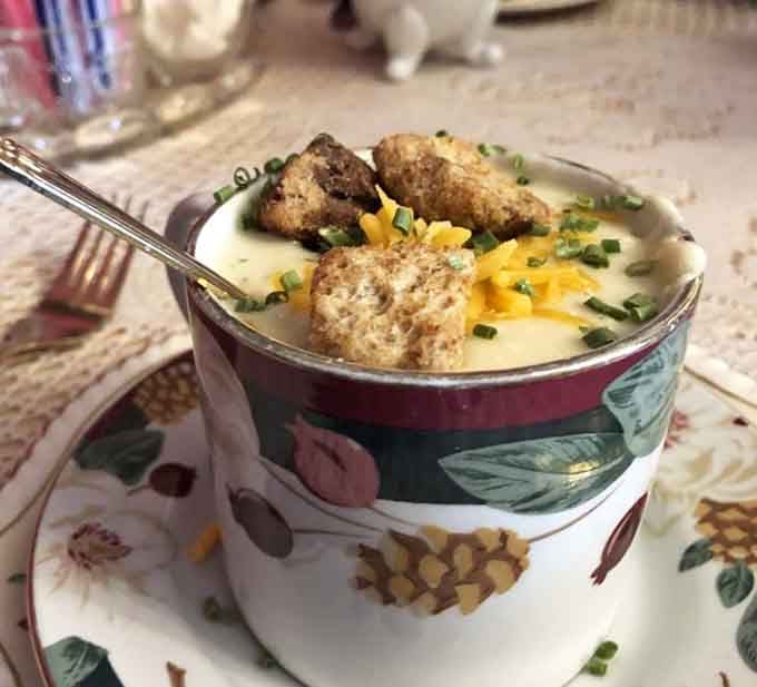Loaded baked potato soup served in vintage china because even comfort food deserves proper presentation.
