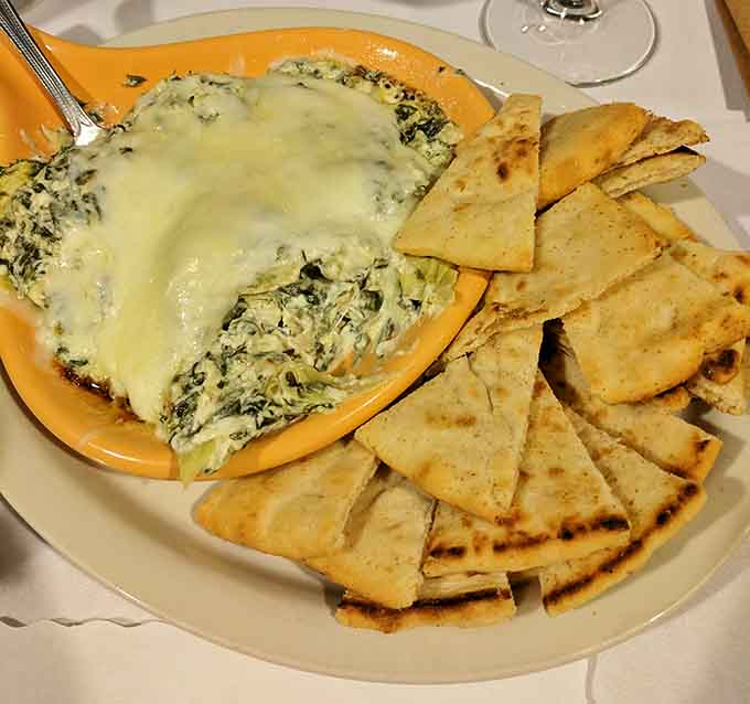 Spinach artichoke dip so good it could end friendships over who gets the last scoop of cheesy, melted perfection.
