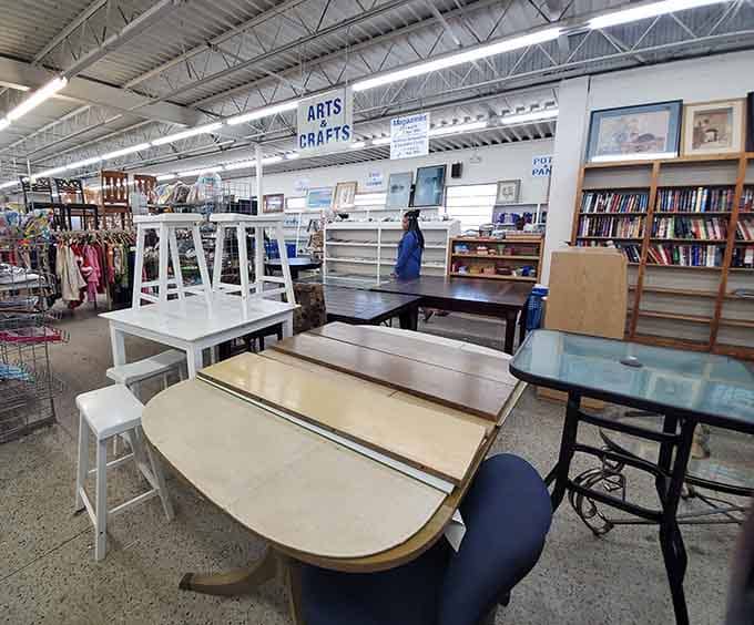 Tables and desks arranged like a furniture showroom where everything's actually affordable and nothing requires assembly instructions from Sweden.
