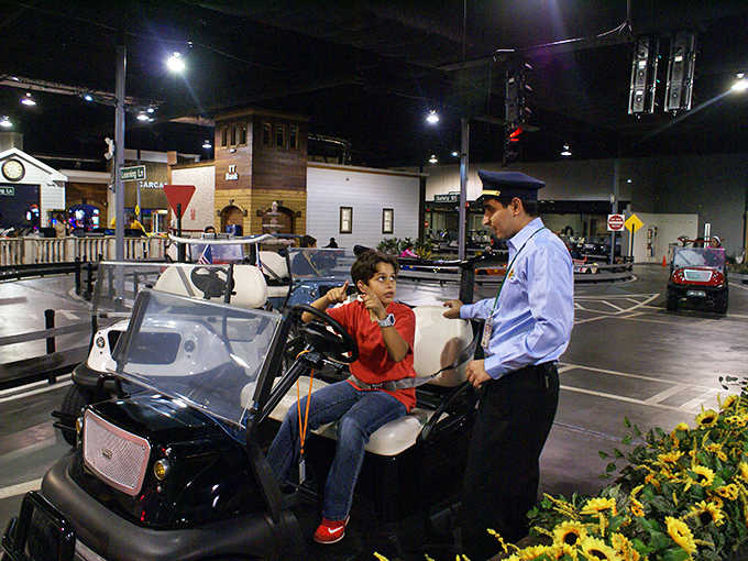 Patient staff members ensure every young driver understands the rules before embarking on their miniature road adventure.