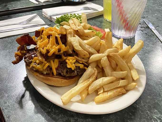 That burger's got more cheese than a 1970s variety show, and the fries are basically begging to be eaten.