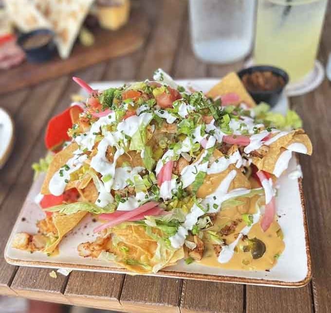 Nachos piled high with toppings that create a beautiful, delicious mess you'll happily navigate with every bite.