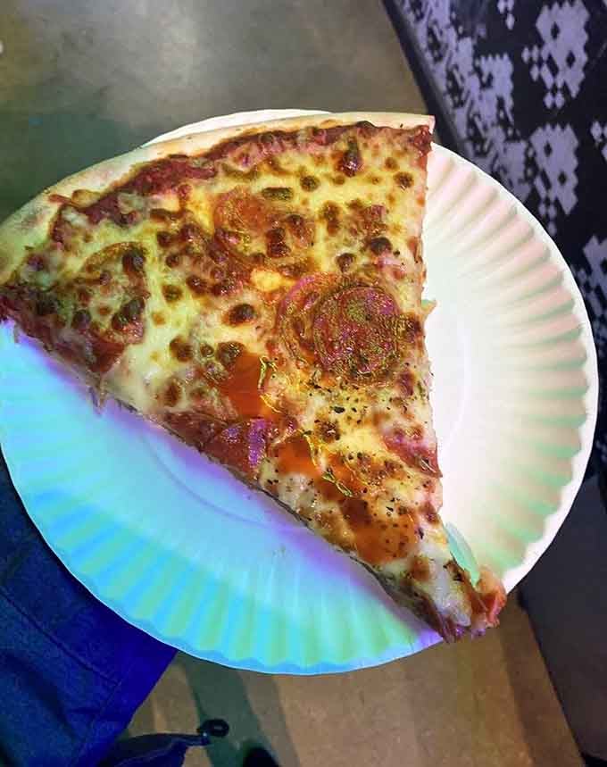 Pizza by the slice means you can fuel up between games without committing to a whole pie.